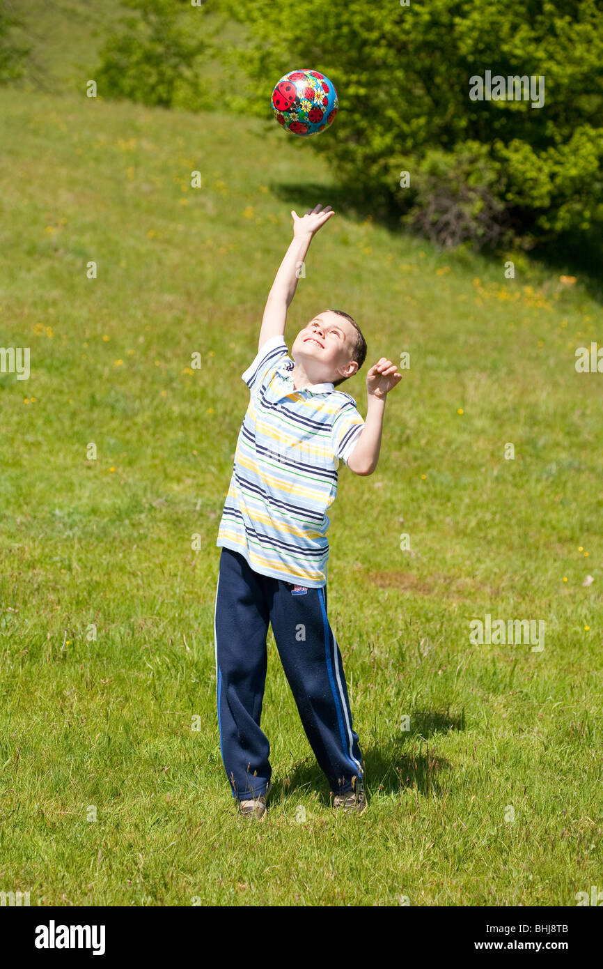 Cute boy playing football outdoor Stock Photo - Alamy
