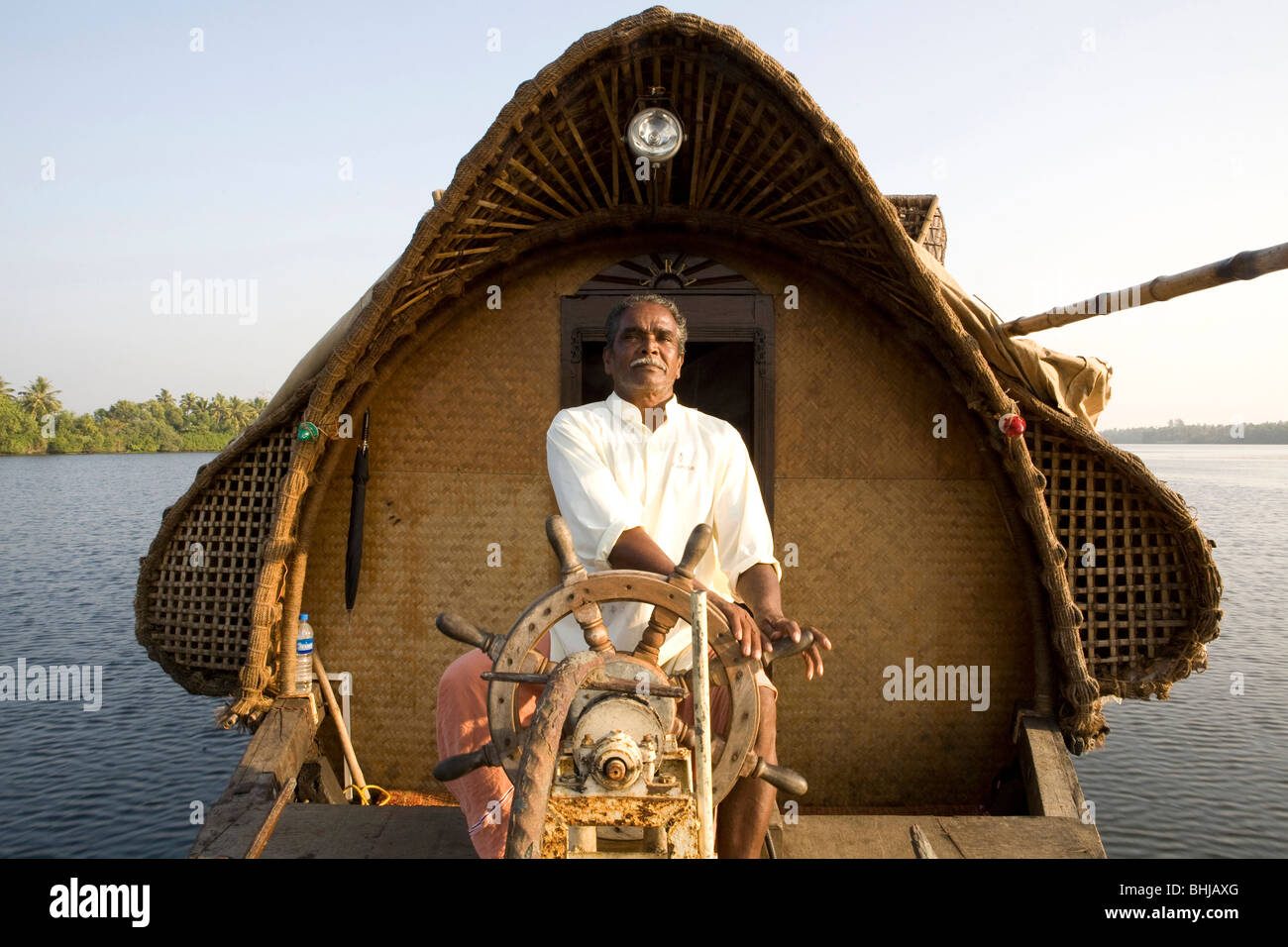 Kerala southern india backwater houseboat trip captain Stock Photo - Alamy