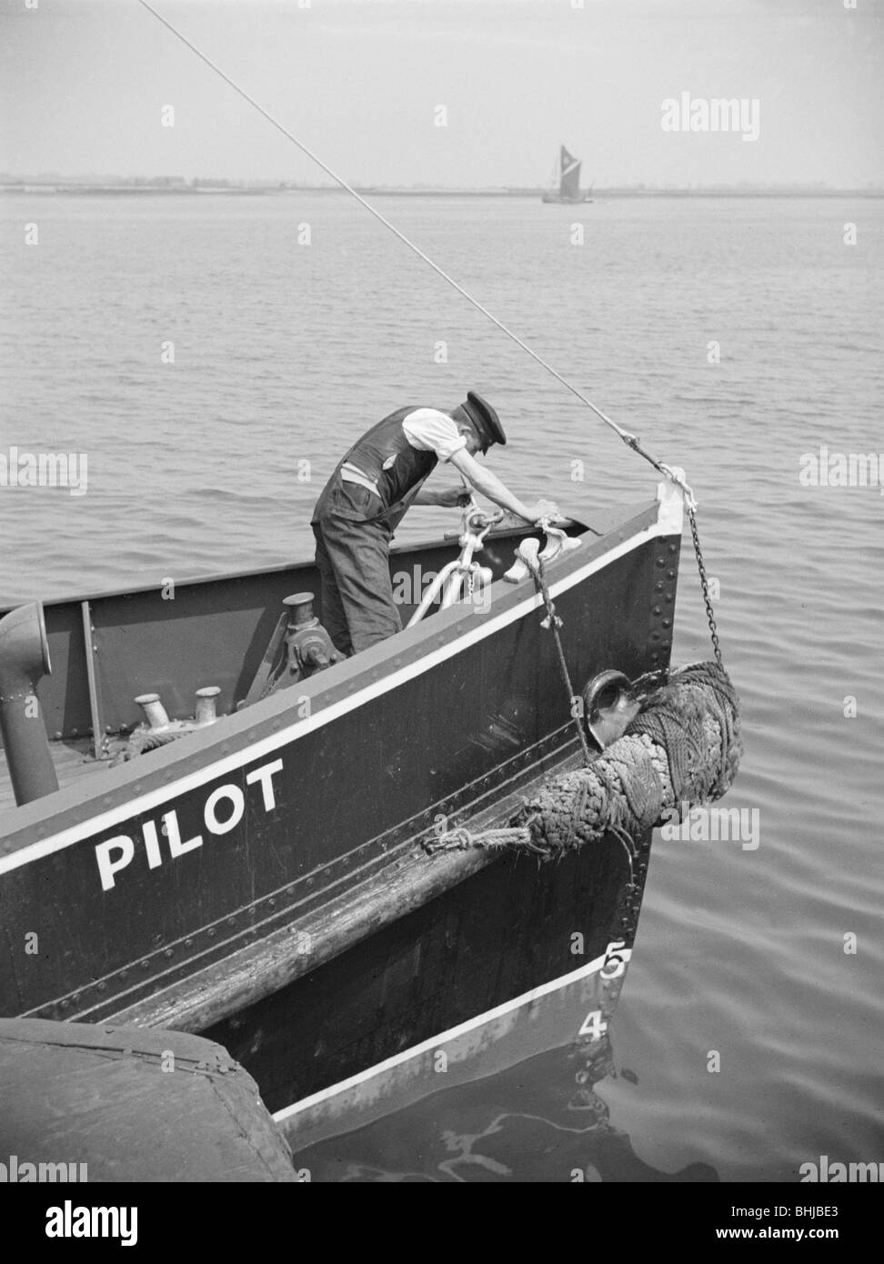 A man working on the bow of a River Thames pilot boat, c1945-c1965 ...