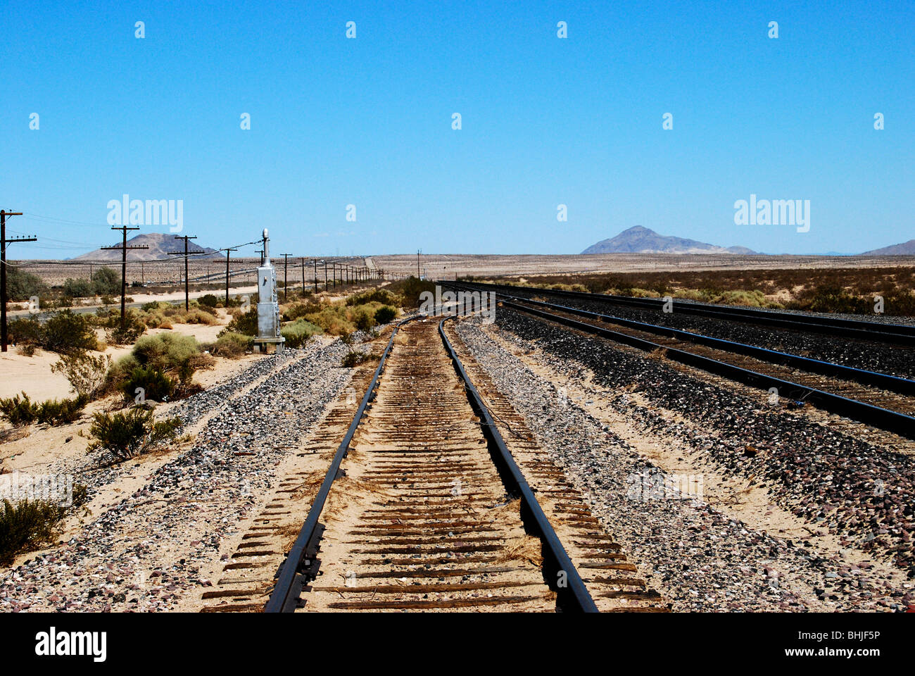 railroad tracks with power lines running one side of tracks Stock Photo ...