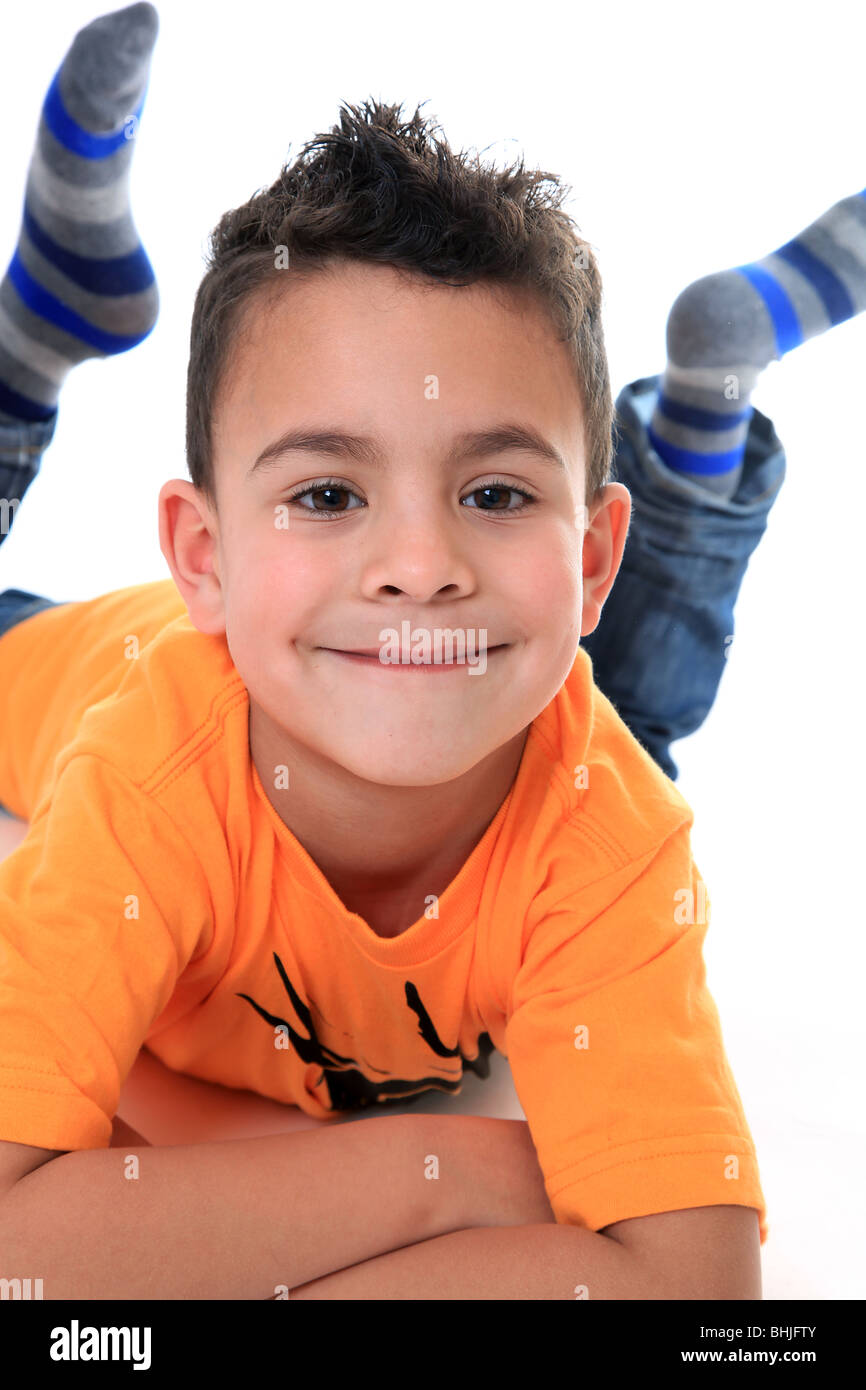 Boy lying on stomach posing for camera Stock Photo - Alamy