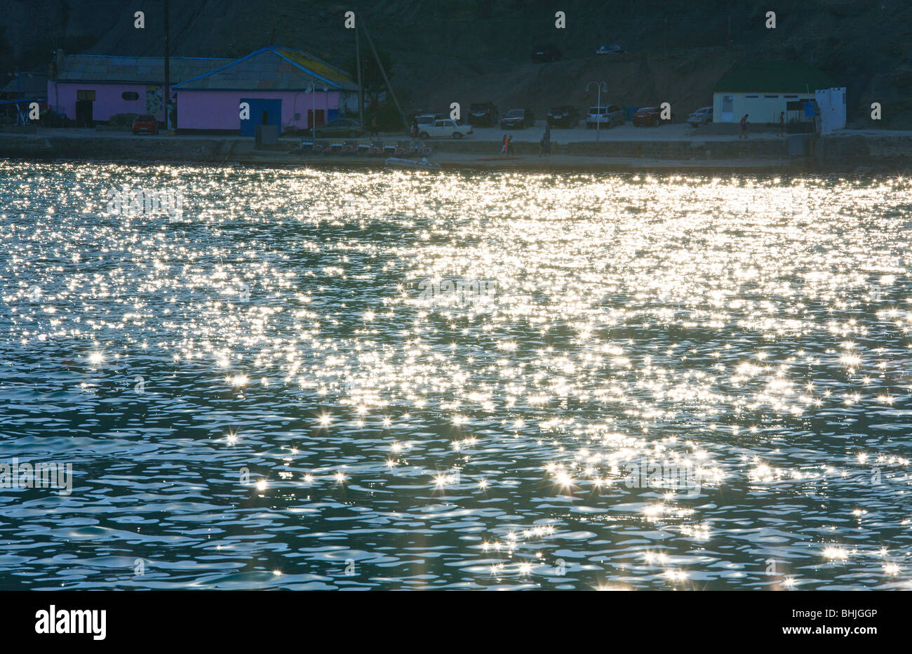 Scintillate sea surface and house on beach (Sudak, Crimea, Ukraine ...