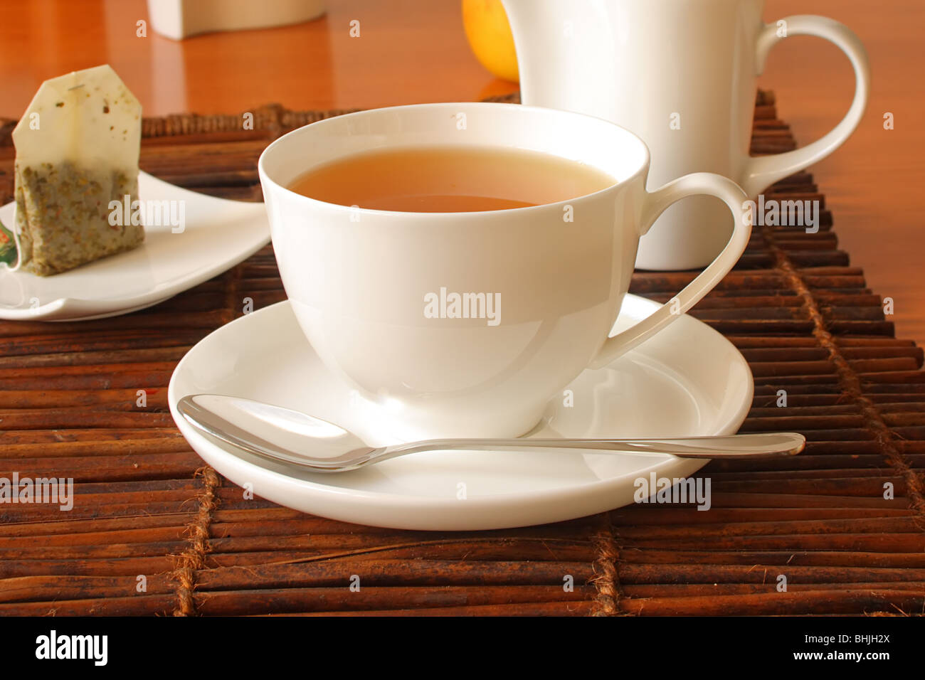 Spoon, cup of tea, sugar and teabag Stock Photo - Alamy