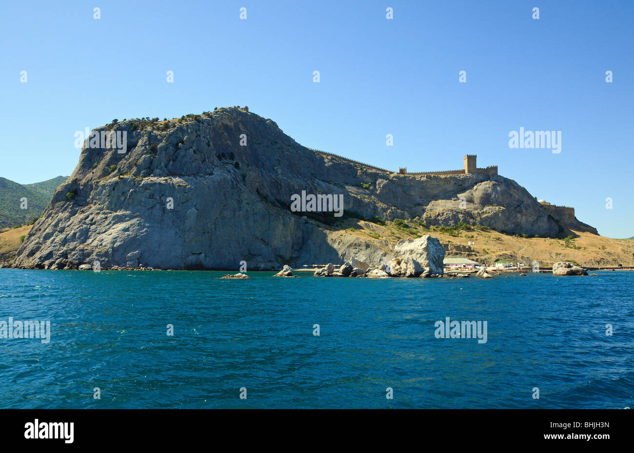 Summer rocky coastline and Genoese fortress (Sudak Town, Crimea ...