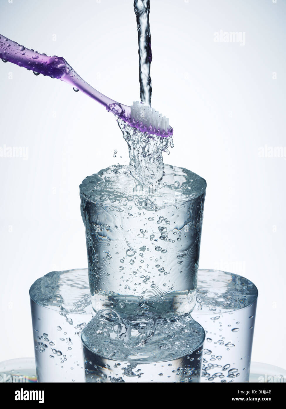 Toothbrush under running water Stock Photo - Alamy