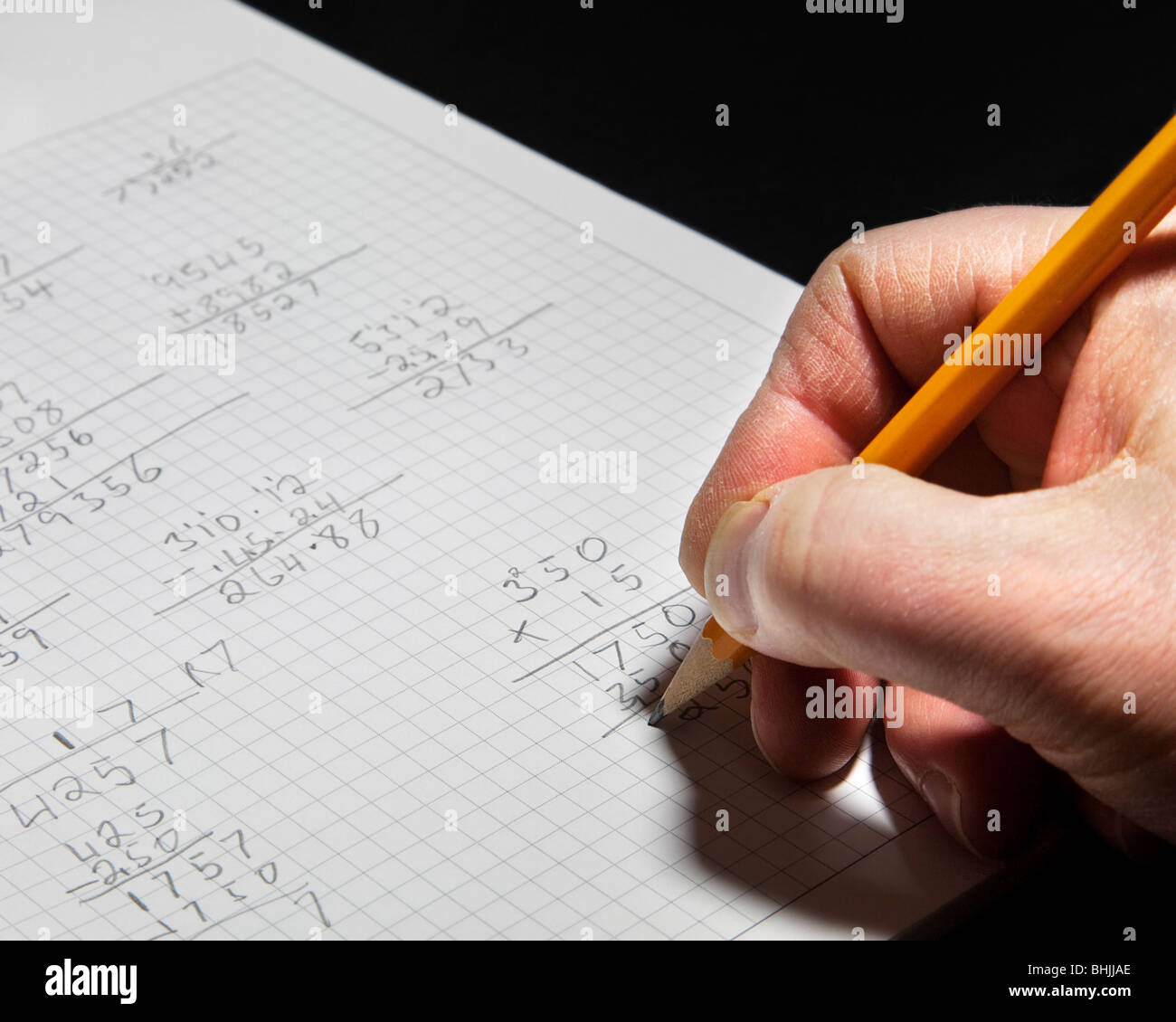 Working out arithmetic sums on a piece of paper with a pencil Stock ...