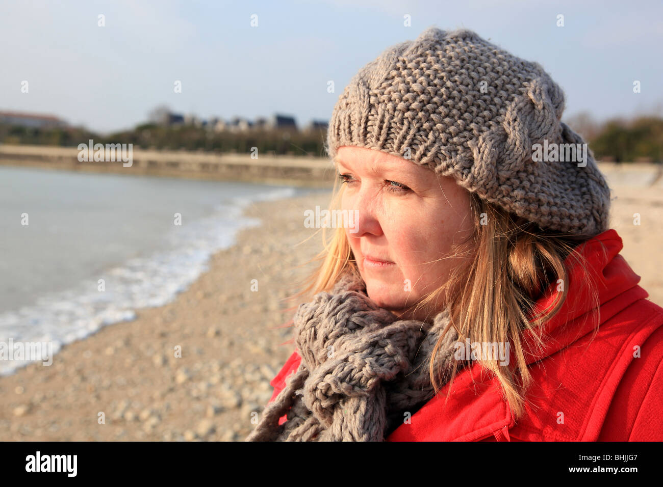Woman looking sad on beach Stock Photo - Alamy