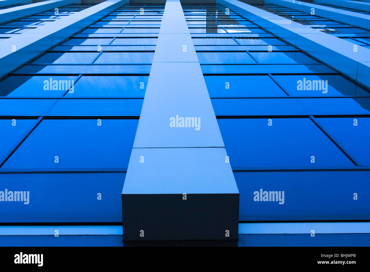 Looking up blue building side with reflective clouds Stock Photo - Alamy