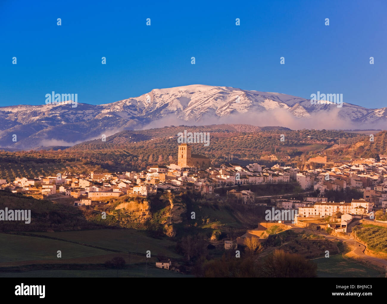 Alhama de Granada with snow covered mountains in distance, Granada ...