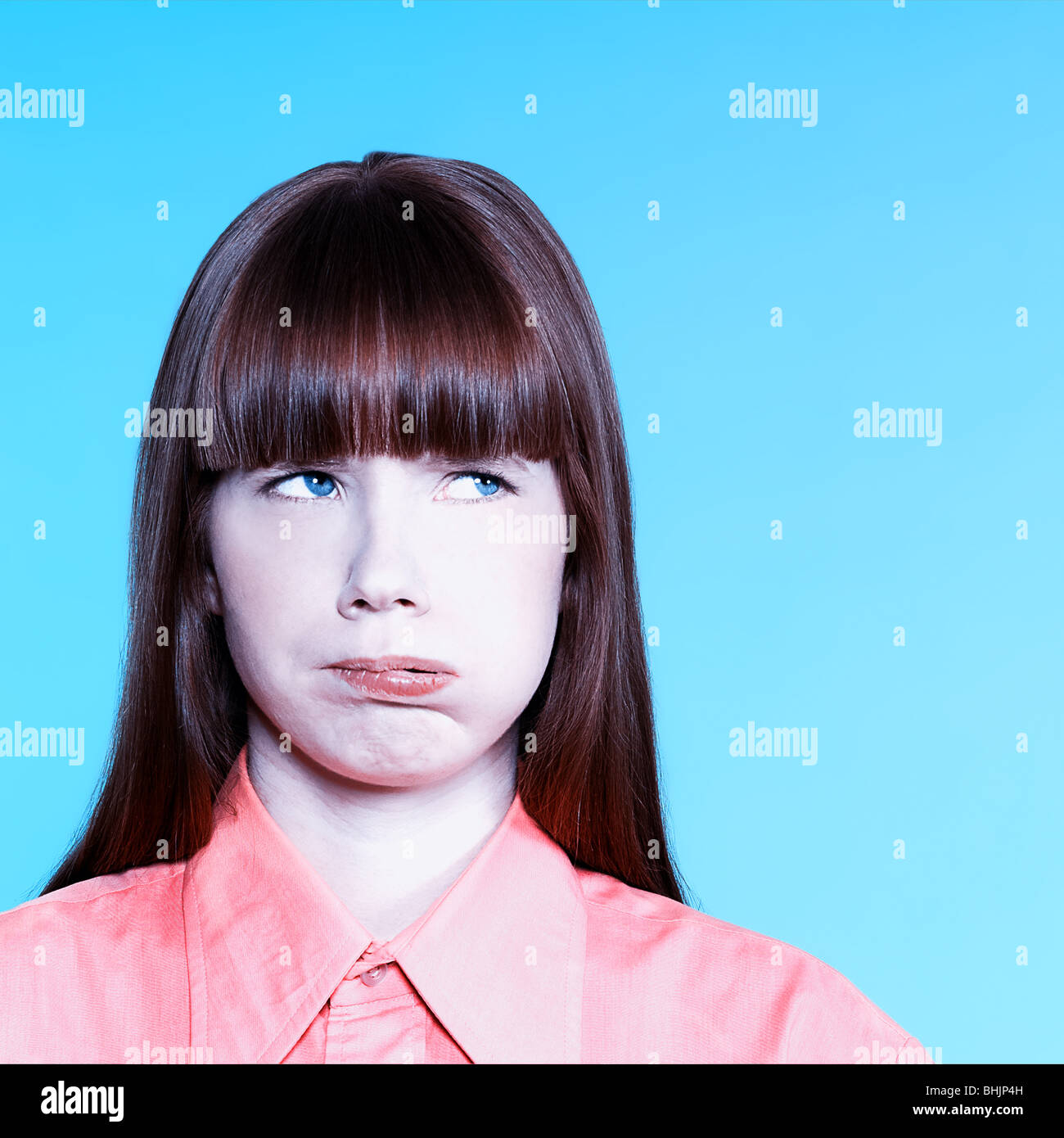 studio portrait of a young bored woman on isolated background Stock ...