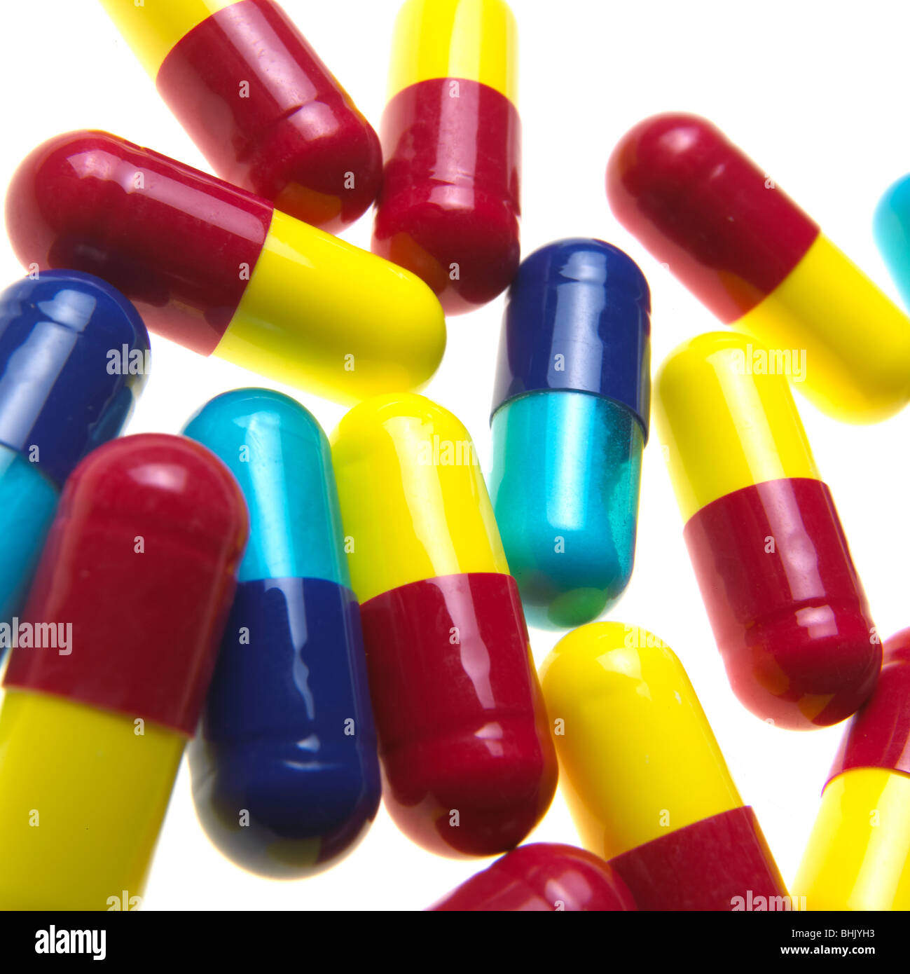 blue, red and yellow flu capsules on a white background Stock Photo - Alamy