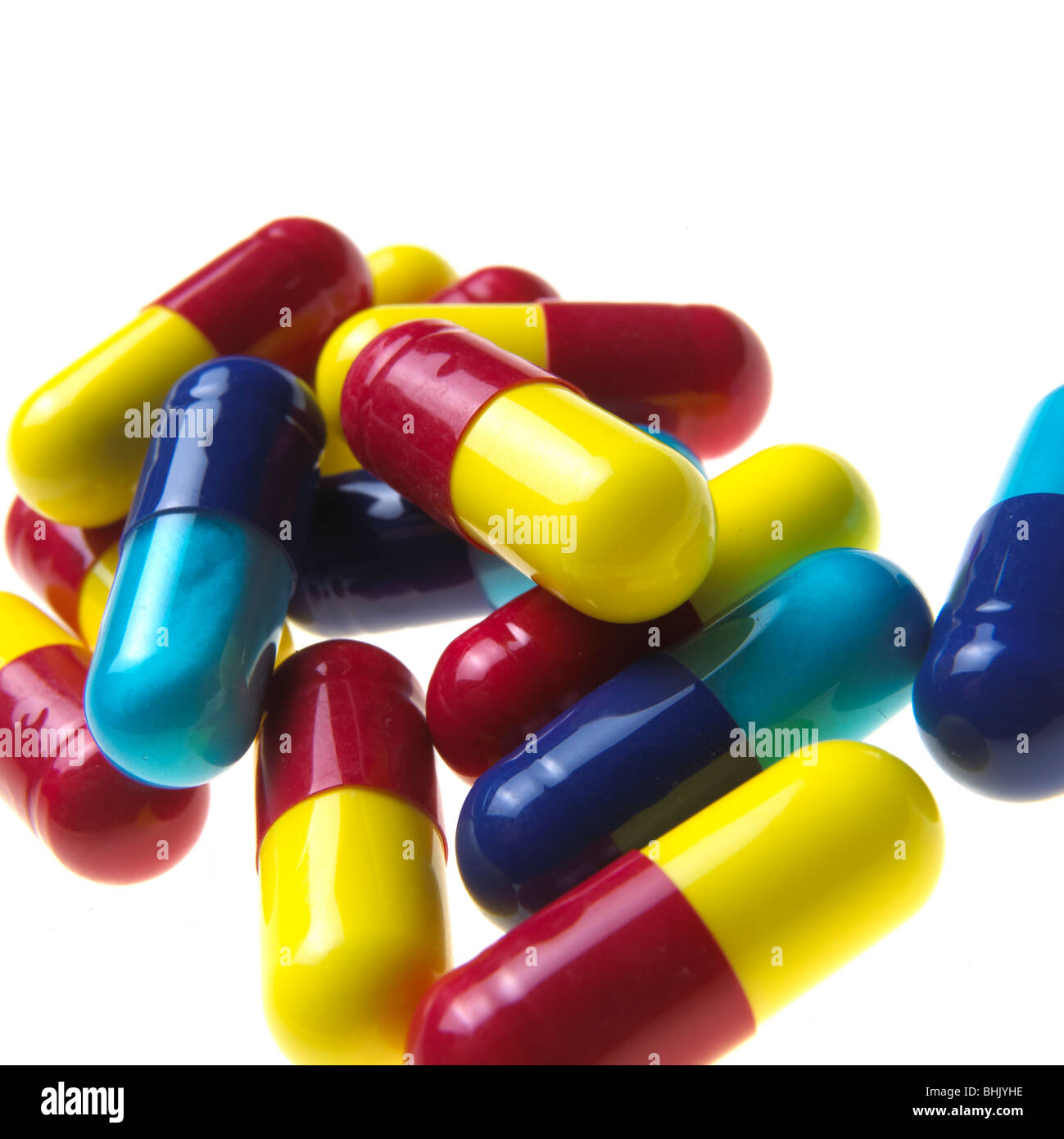 blue, red and yellow flu capsules on a white background Stock Photo - Alamy