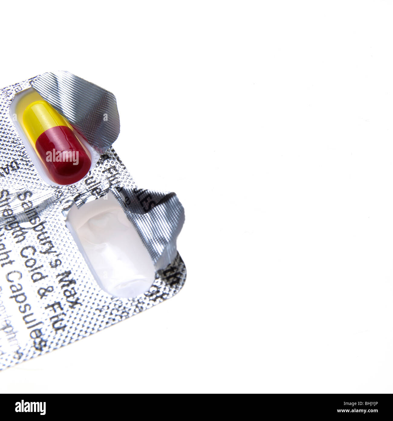 blue, red and yellow flu capsules on a white background Stock Photo - Alamy