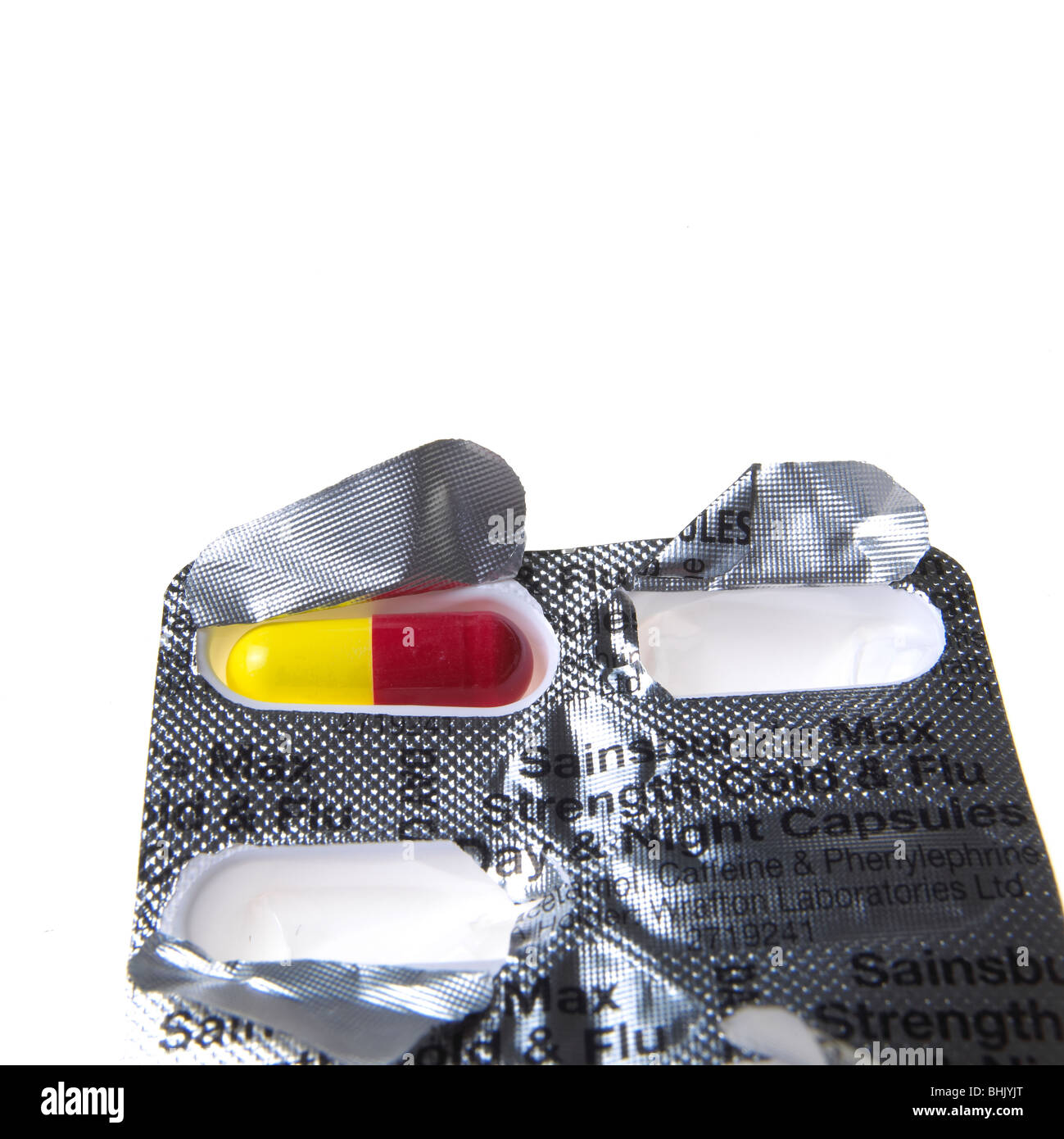 blue, red and yellow flu capsules on a white background Stock Photo - Alamy