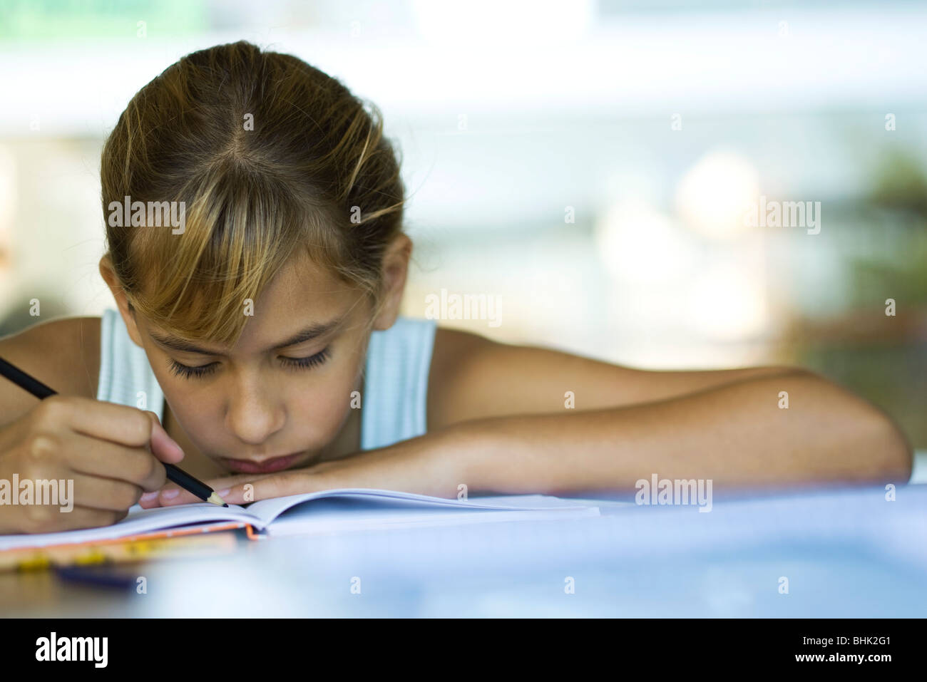 Female junior high student writing homework assignment Stock Photo - Alamy