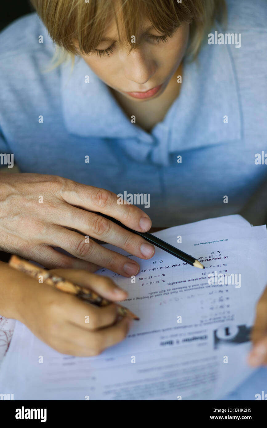 Male junior high student listening as teacher explains difficult ...