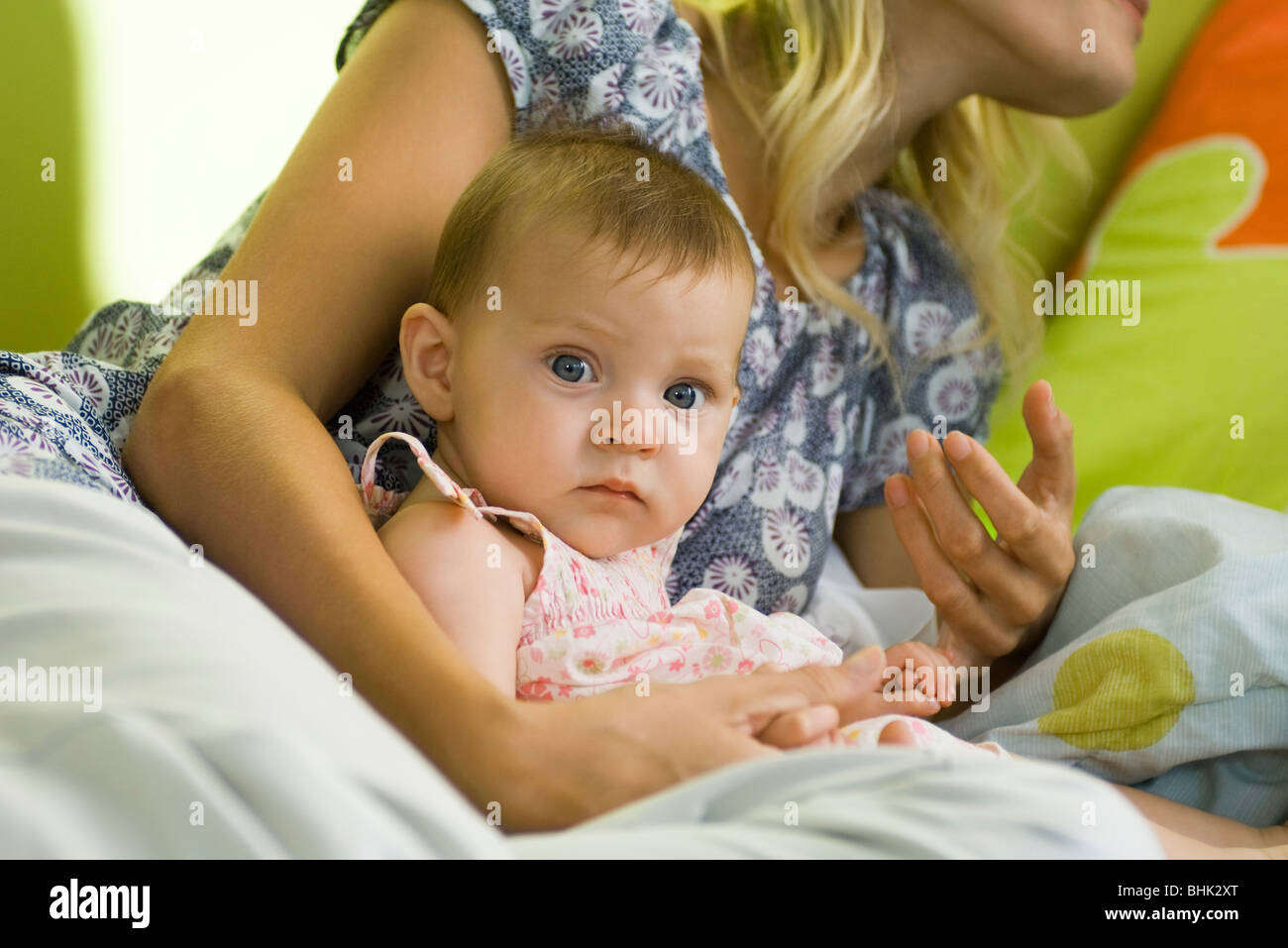 Infant in arms of mother Stock Photo - Alamy