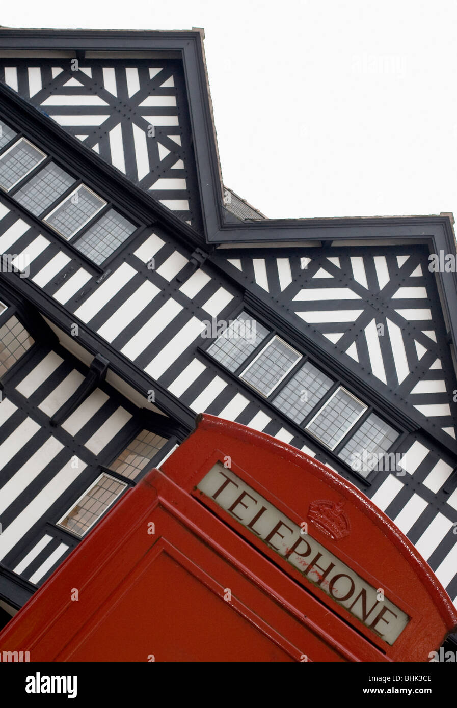Red telephone box and timber framed building in typical old english ...
