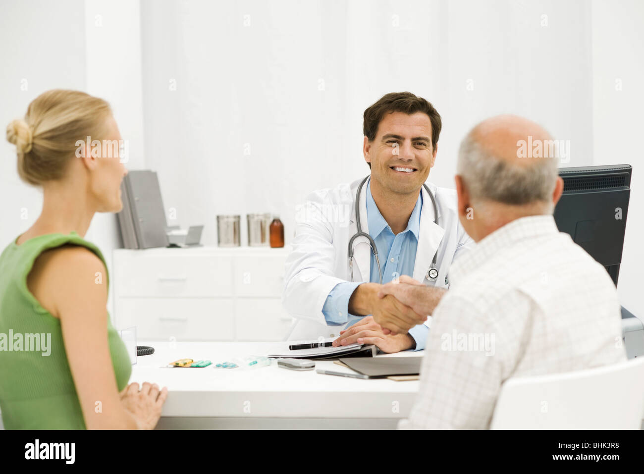 Doctor with senior patient providing medical consultation Stock Photo ...