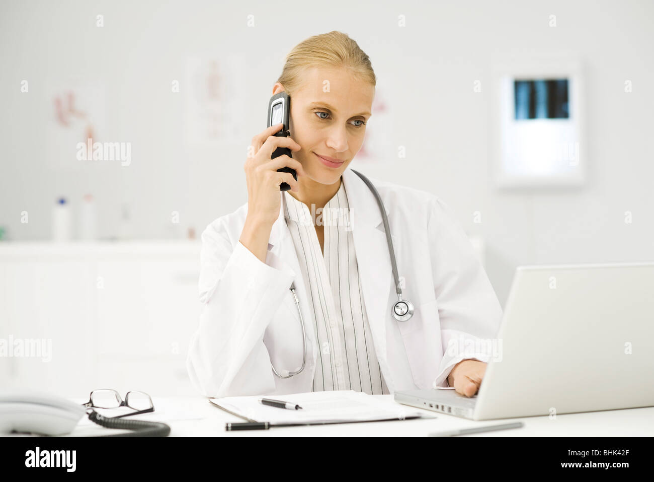 Female doctor multitasking hi-res stock photography and images - Alamy