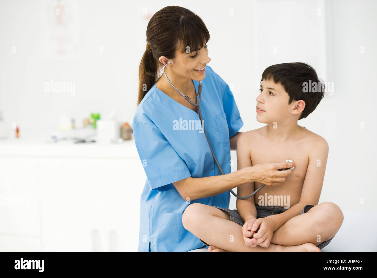 Nurse examining boy with stethoscope Stock Photo - Alamy