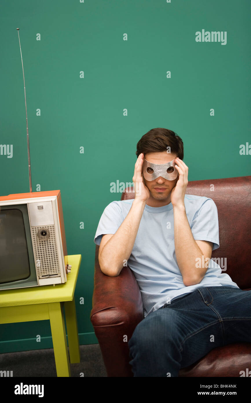 Man concealing identity behind mask Stock Photo - Alamy
