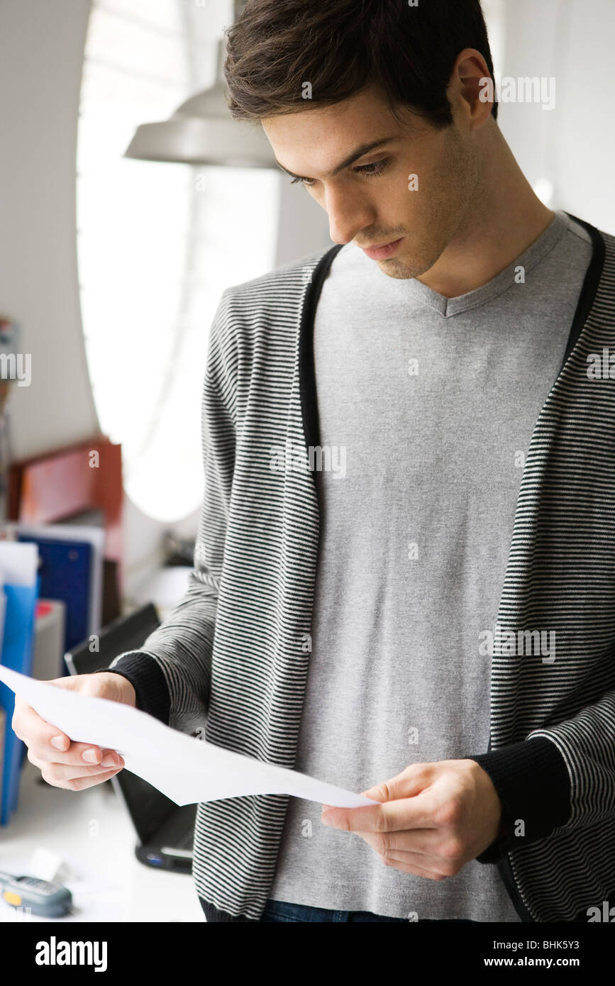 Man reviewing document Stock Photo - Alamy