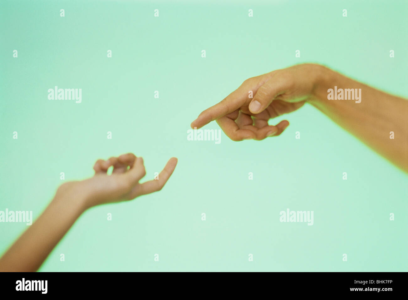 Two hands reaching toward each other with index fingers extended Stock ...