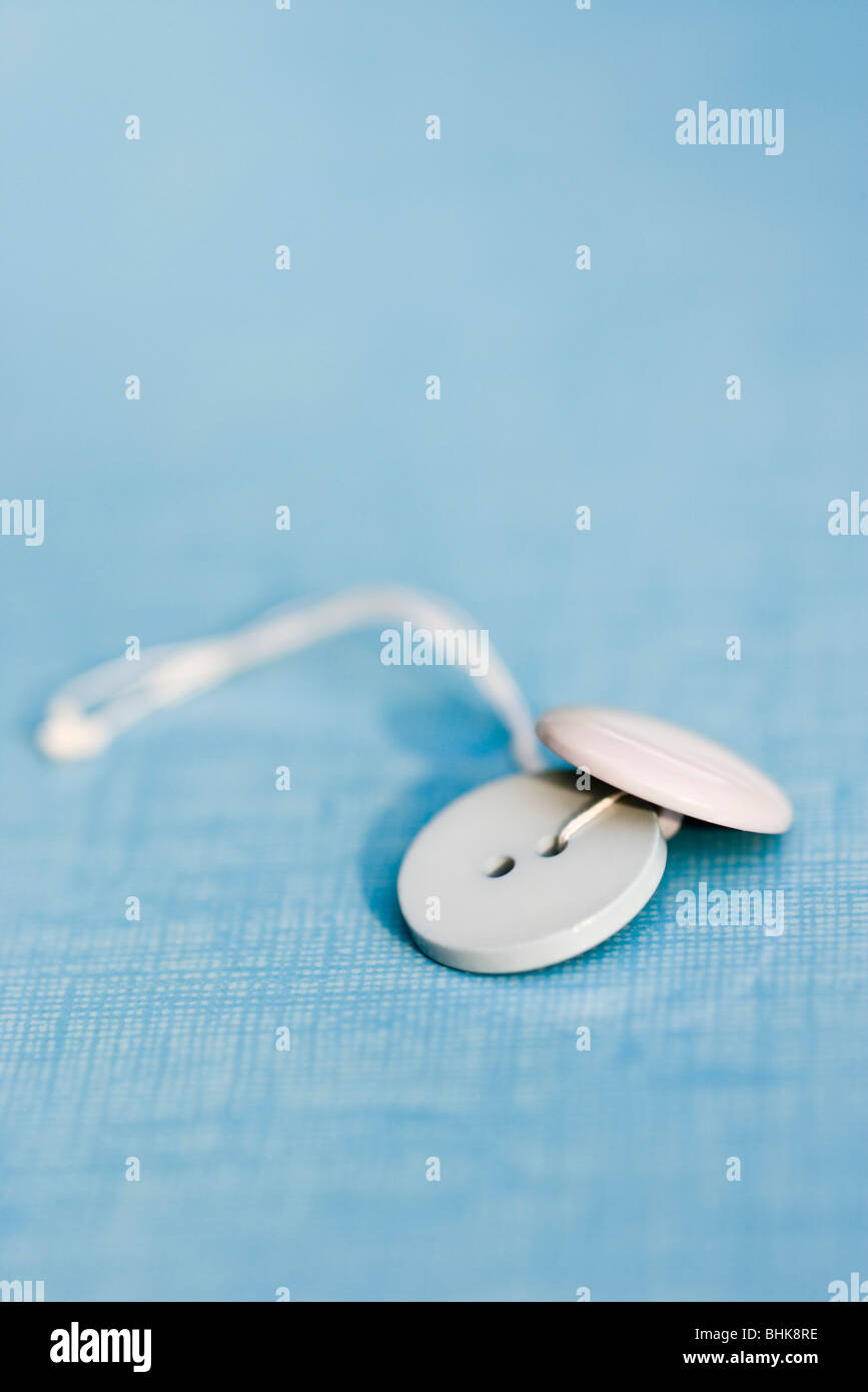 Buttons threaded together Stock Photo - Alamy