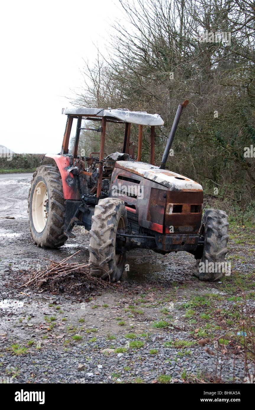 Burnt out stolen tractor in a countryside lane Stock Photo - Alamy