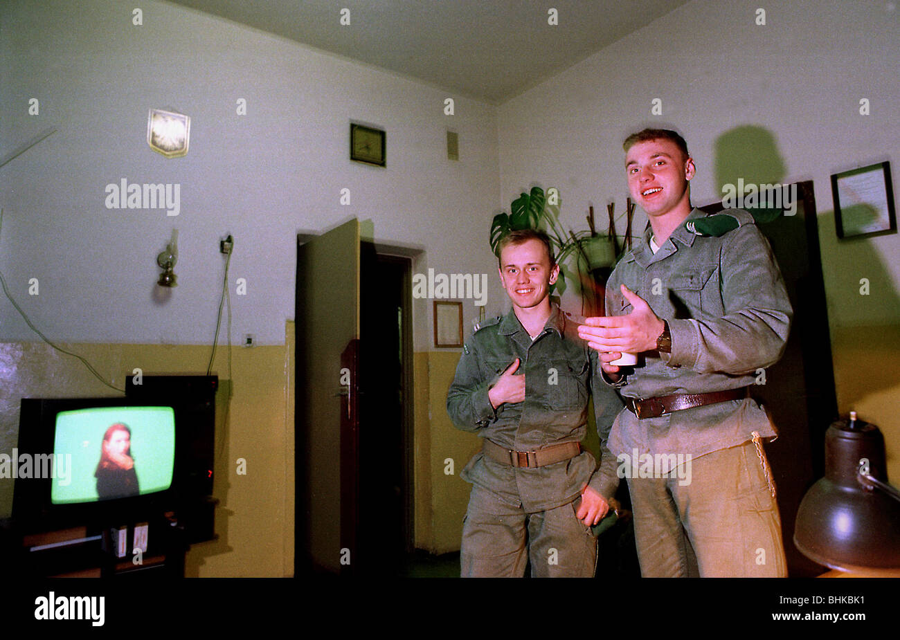 Border guard officers watching TV in the barracks during a night shift ...
