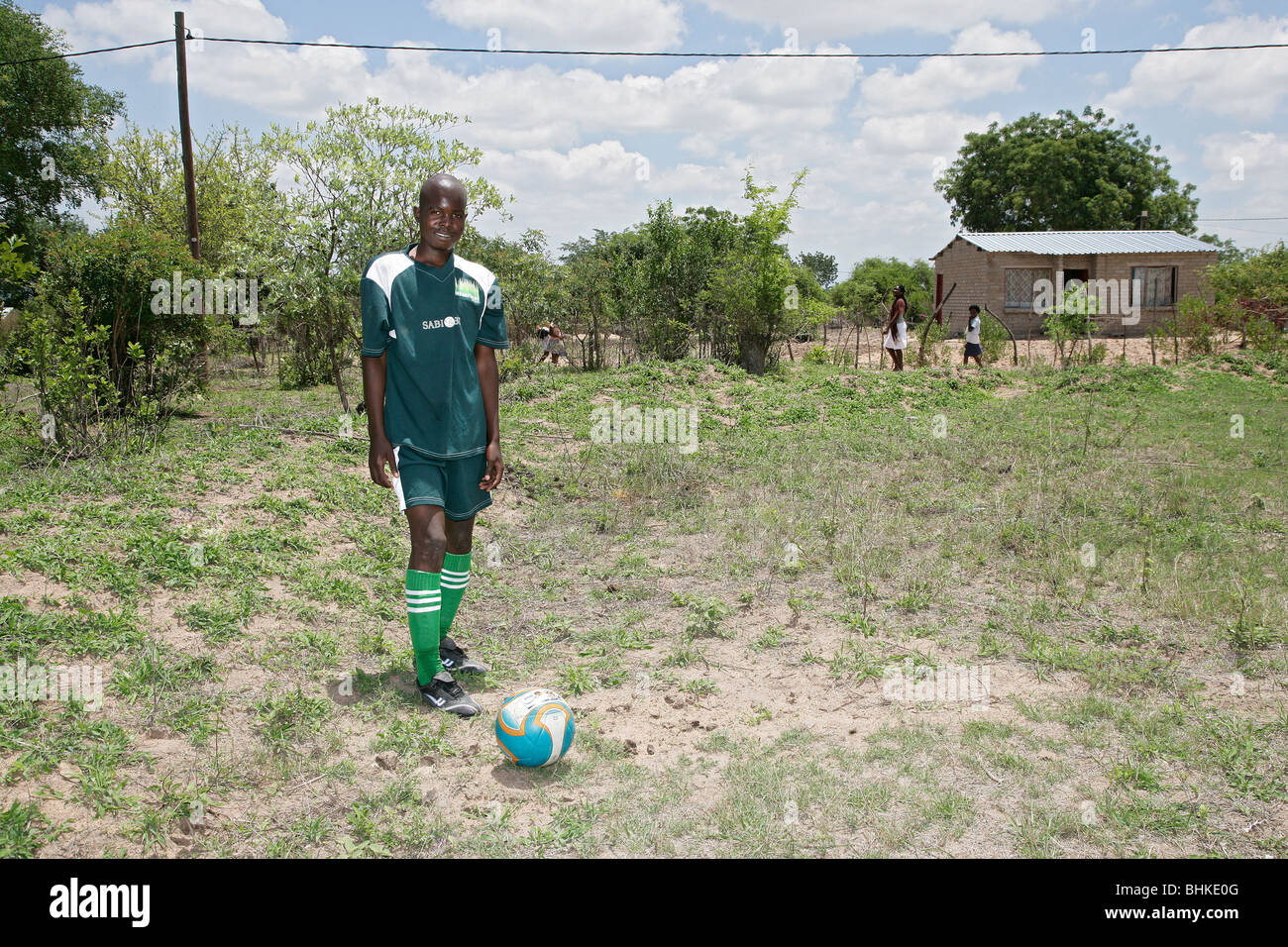 South African school Boy playing football on the school football pitch ...