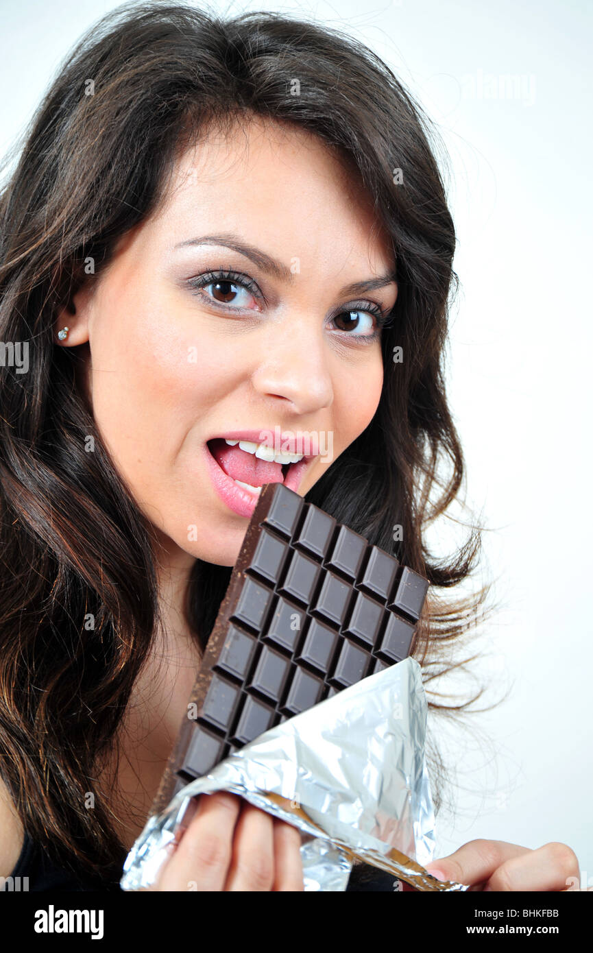 young woman eating chocolate Stock Photo - Alamy