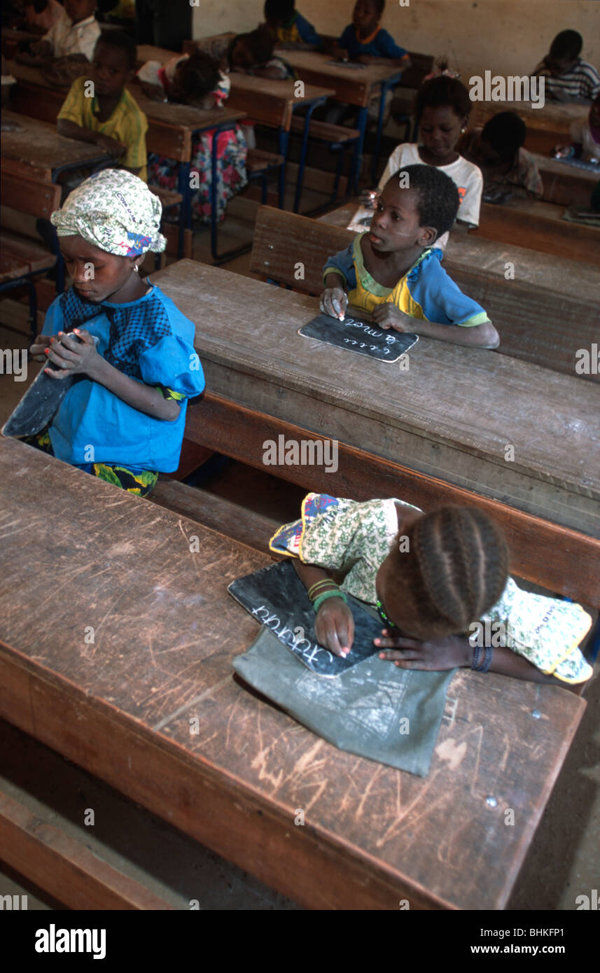 Malian children at school chalking letters and words on their slates ...