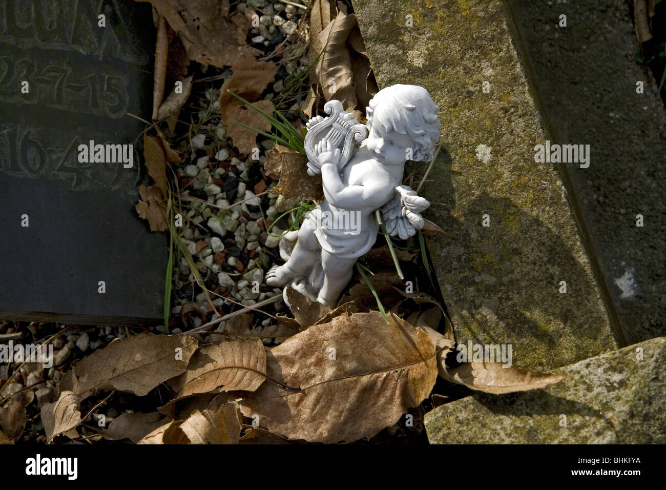 Figurine placed by a grave Stock Photo - Alamy