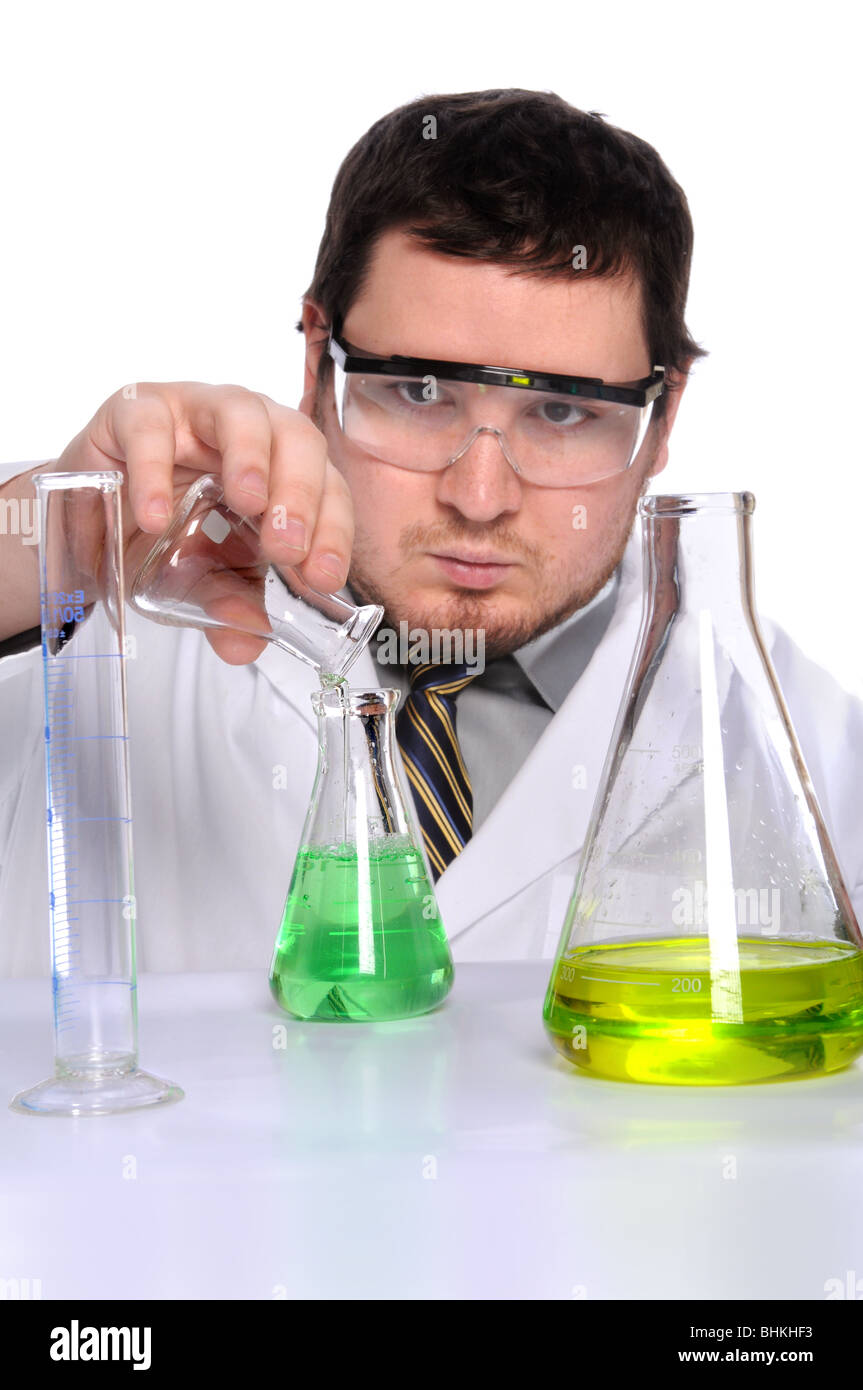Scientist working in laboratory pouring liquid into flask Stock Photo - Alamy