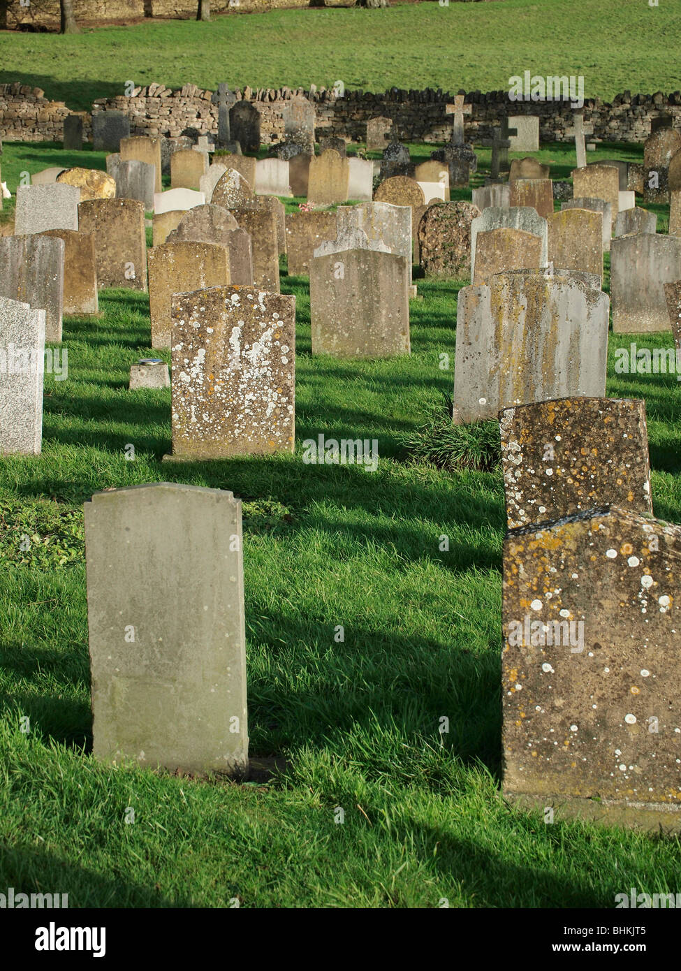 gravestones lit by the sun in a country cemetery Stock Photo - Alamy