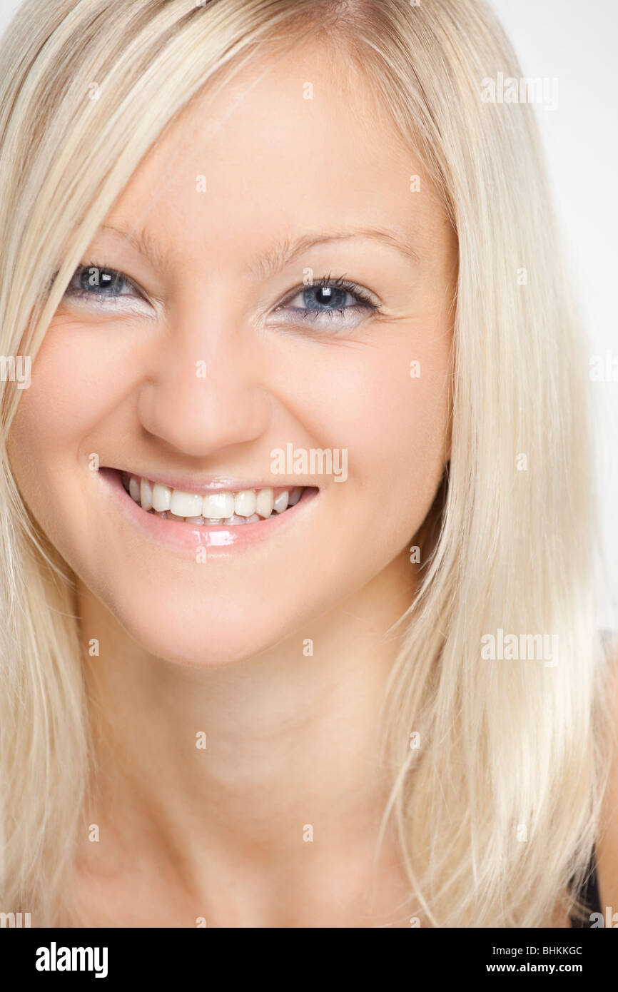 Portrait of a blond girl, smiling Stock Photo - Alamy
