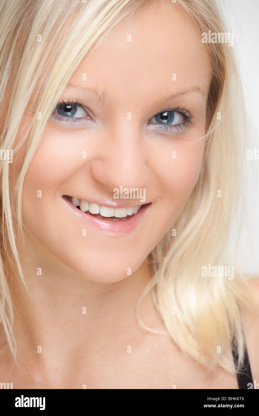 Portrait of a blond girl, smiling Stock Photo - Alamy