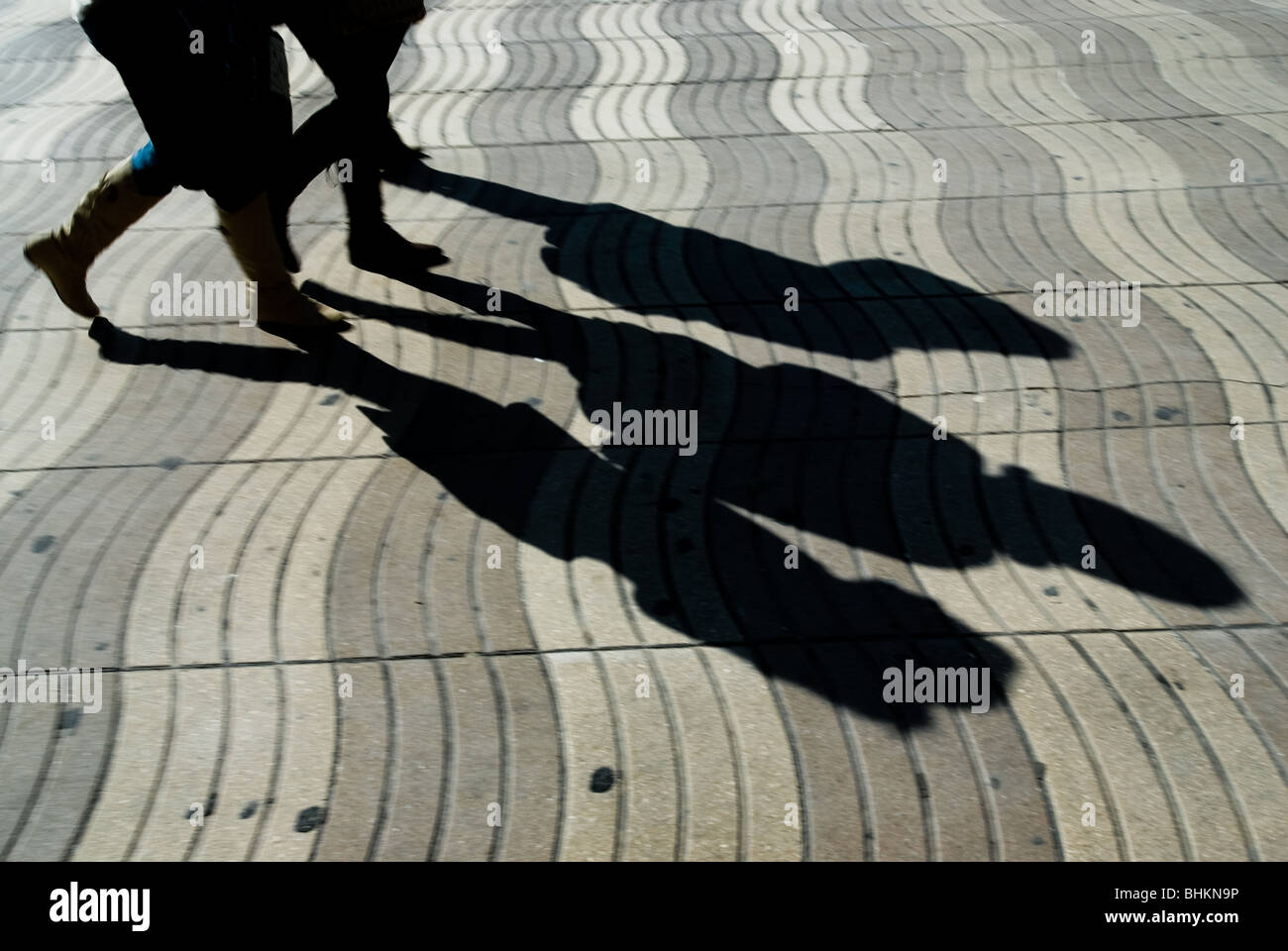 shadows of 3 girls walking on the pavement Stock Photo - Alamy