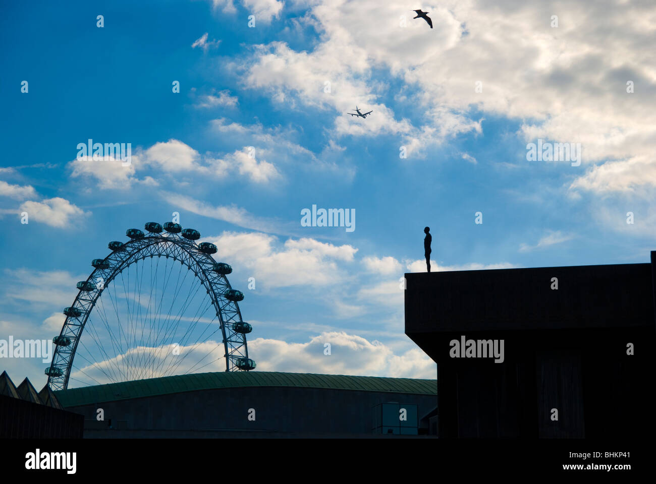 A bird, a plane, a statue of a man, and the Millenium Wheel are seen in ...