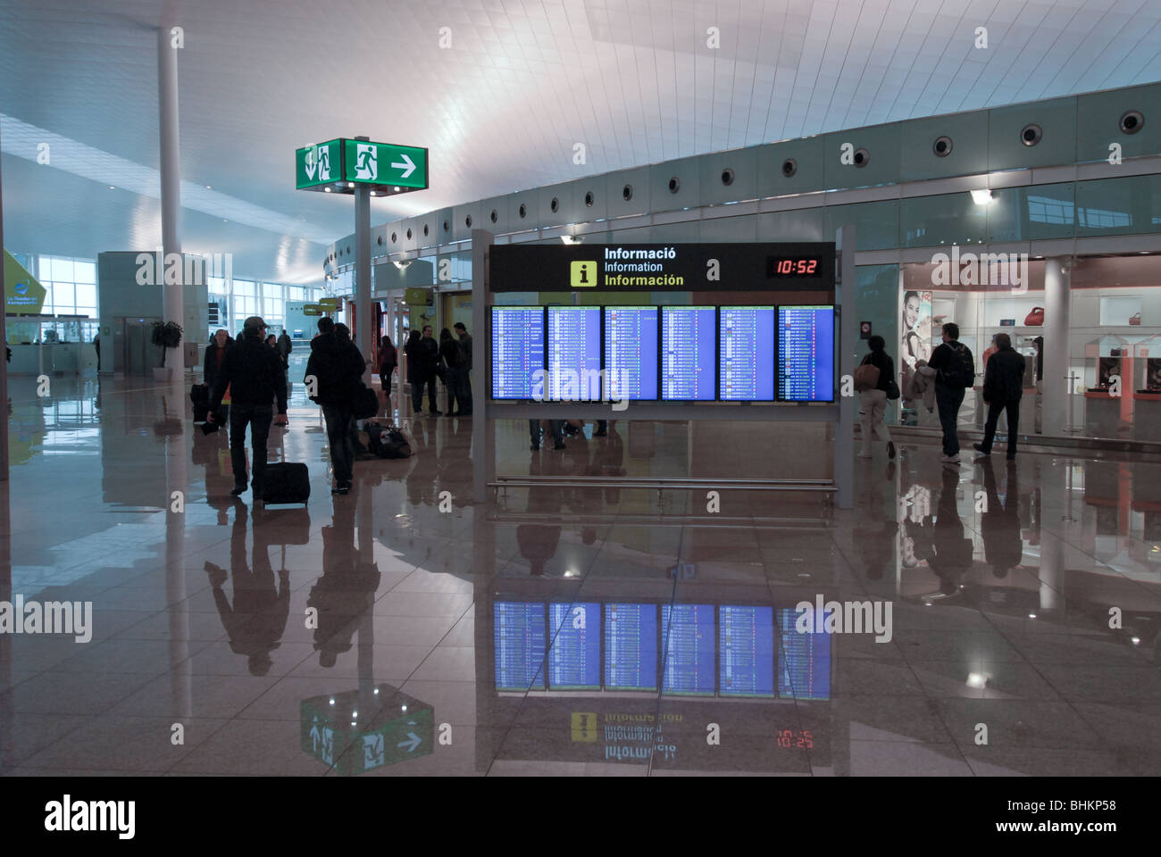 Passengers reads a flight information screen at an airport Stock Photo ...