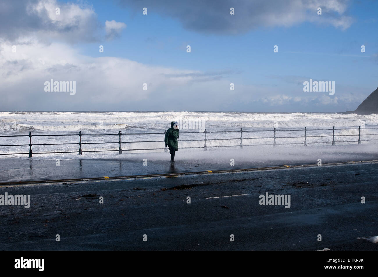 Woman escapes from crashing waves on seafront, Scarborough Stock Photo ...