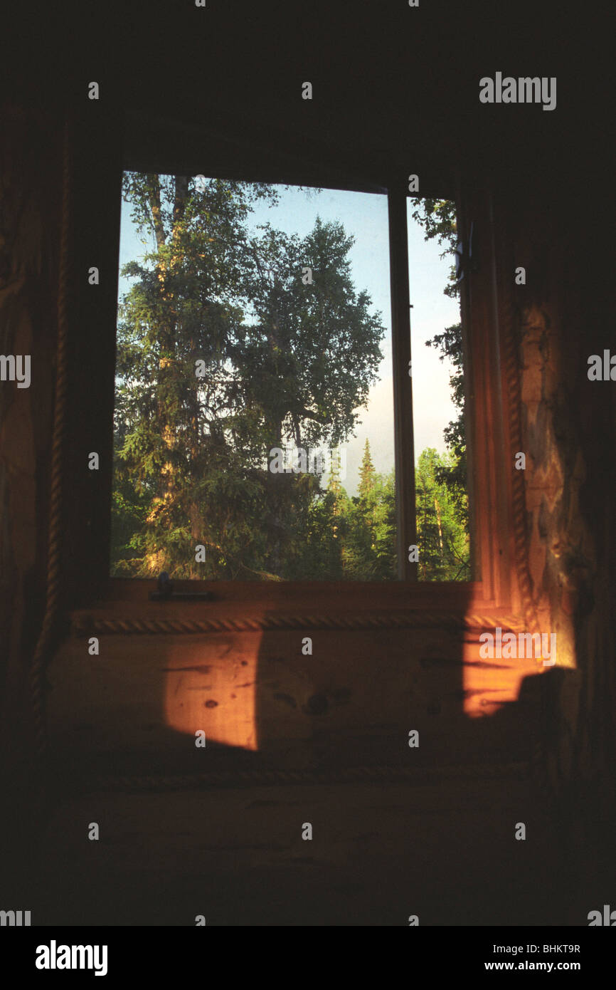 Dawn breaking on the Alaskan wilderness seen from the window of a ...