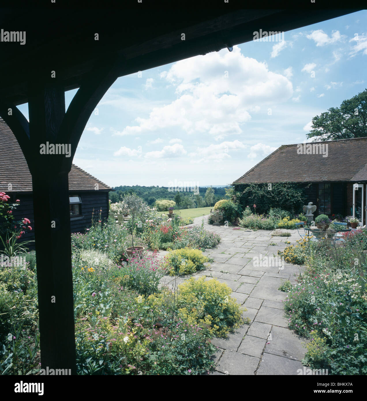 Looking from porch at small country barn conversion with paved ...