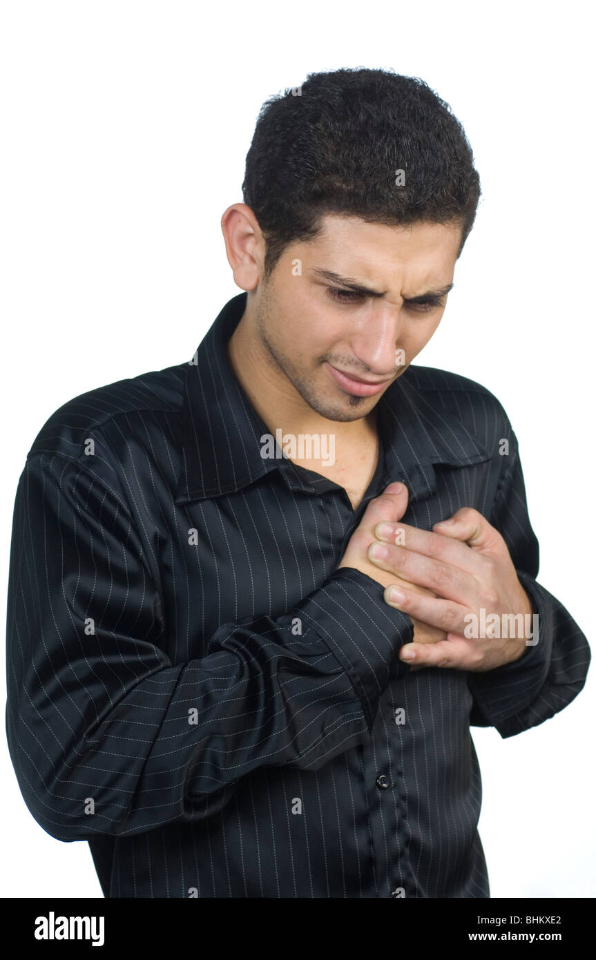 Young man hands over chest having a heartattack against a white ...