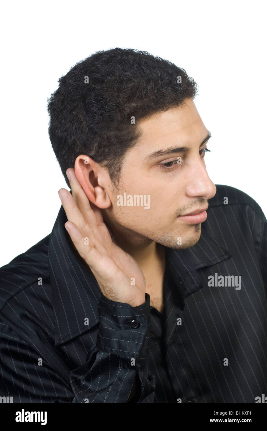 Young man wearing a black shirt hand behind his ear eavesdropping ...