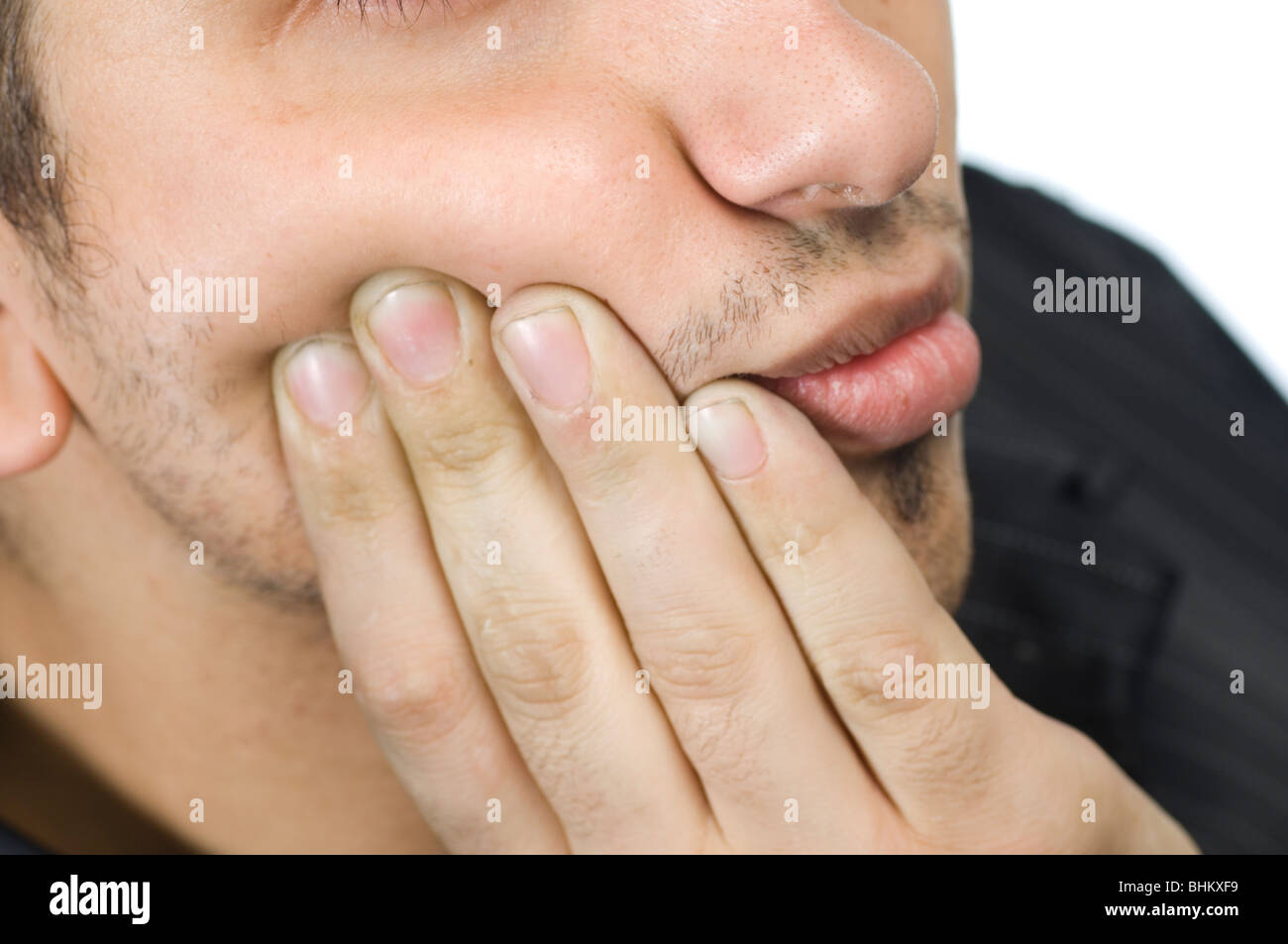 Close up of young man;s hand over mouth Stock Photo - Alamy