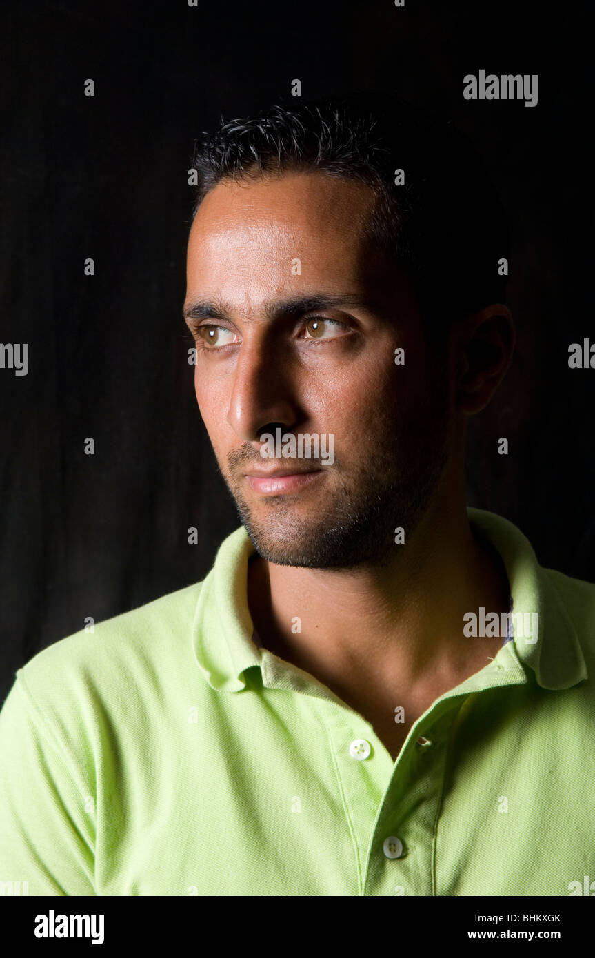 Handsome young man in deep thinking against a black background Stock ...
