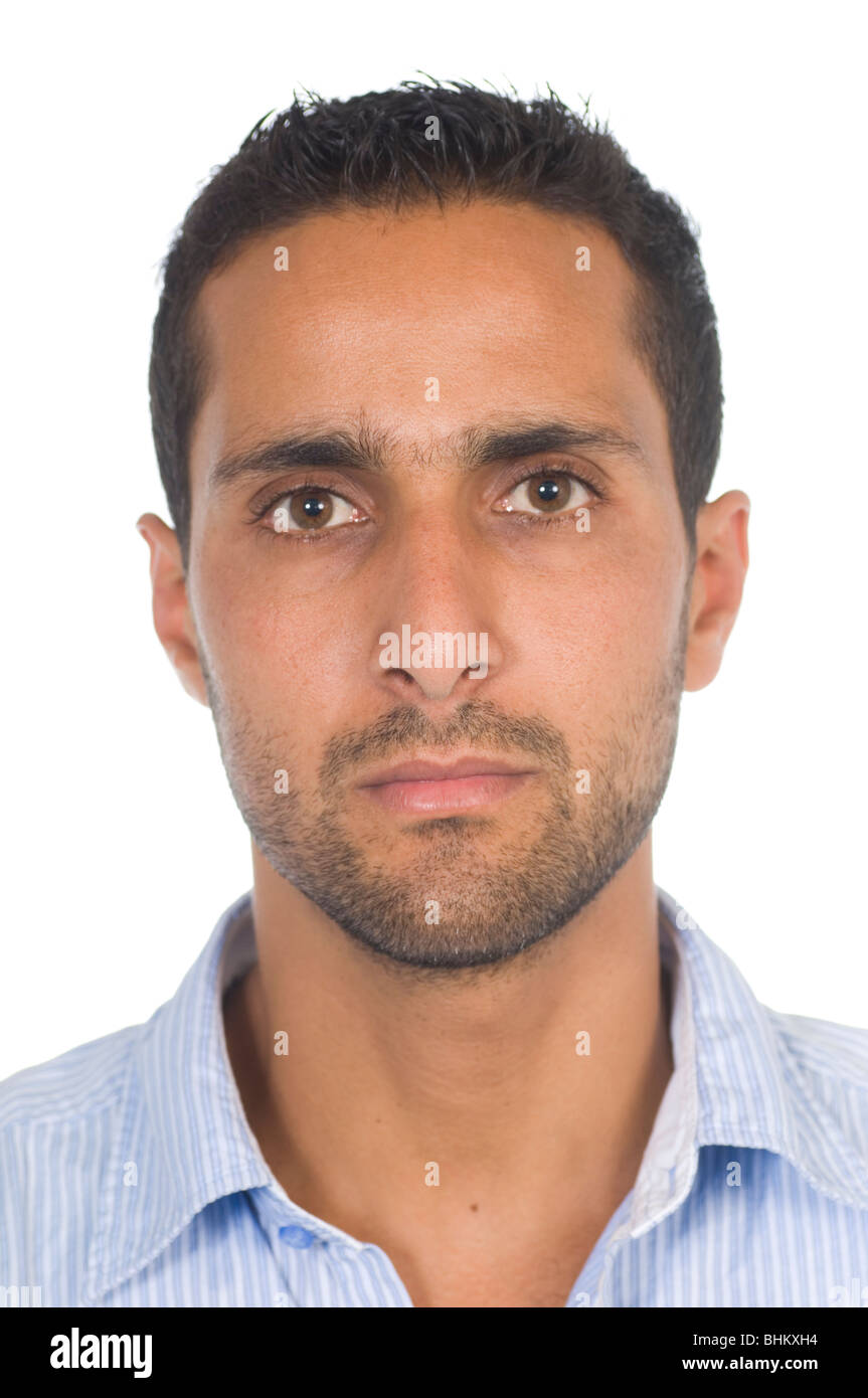Serious young man looking at camera against a white background Stock ...
